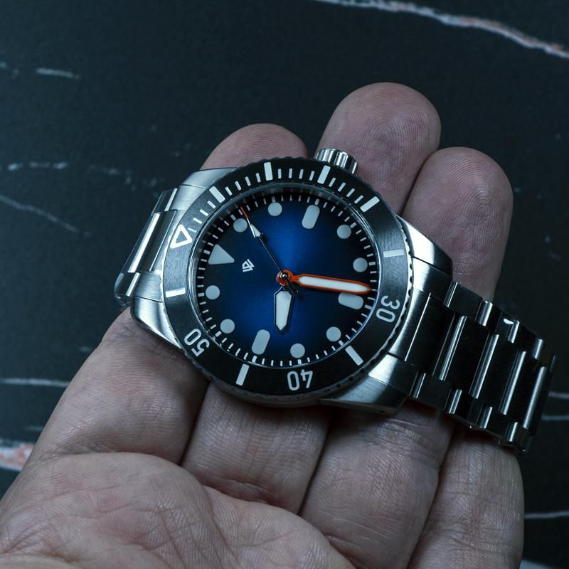 Blue dial, orange minute hand, 3D lume blocks on the indices | WatchCrunch